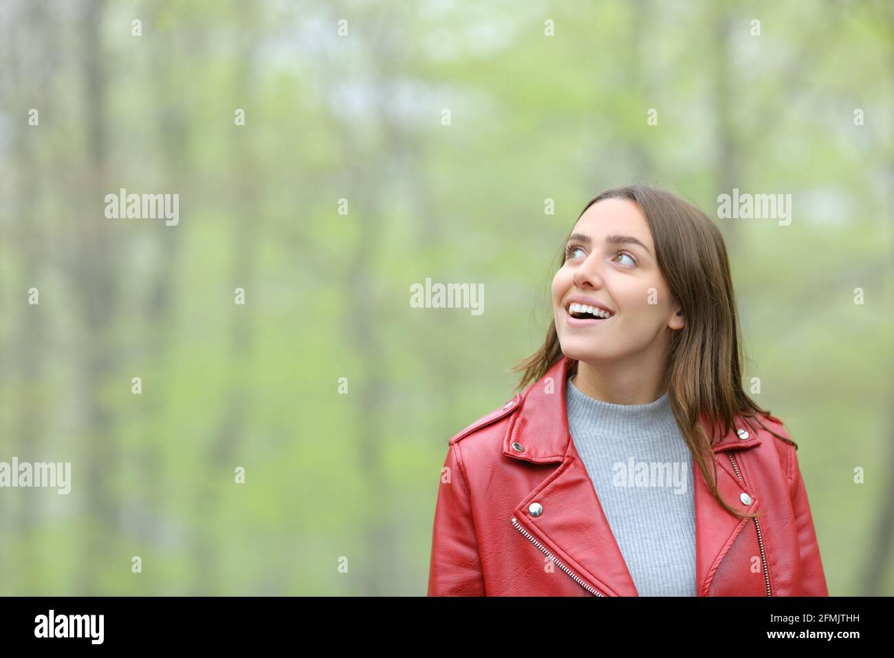 Amazed woman in red contemplating walking in a forest Stock Photo - Alamy