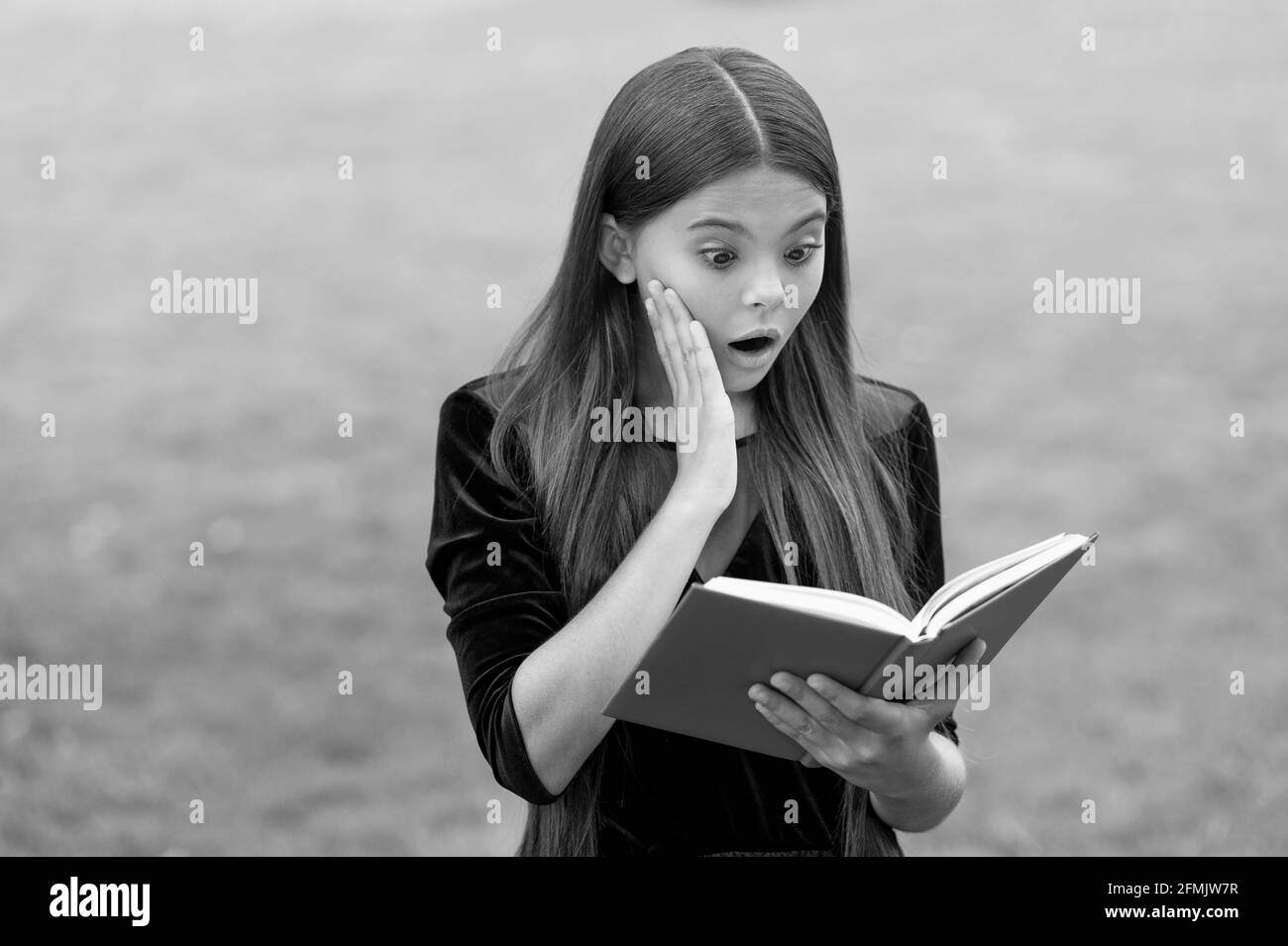Surprise helps to study new things. Surprised child read study book ...