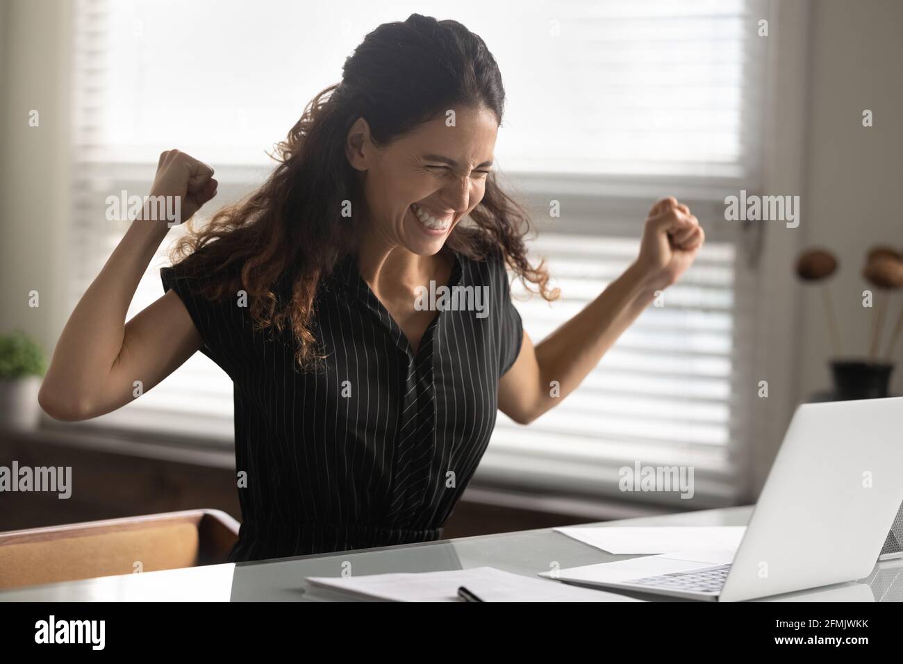 Joyful excited young latin woman receive reward for good job Stock ...