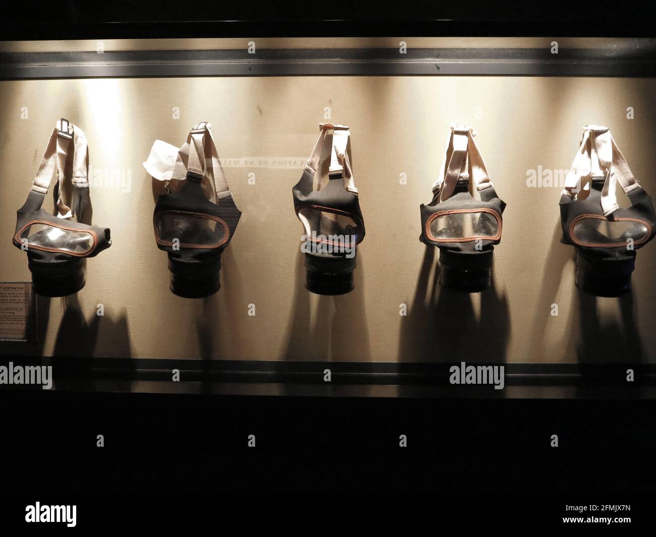 Gas mask display in cabinet in the War Tunnels on the Island of Jersey ...