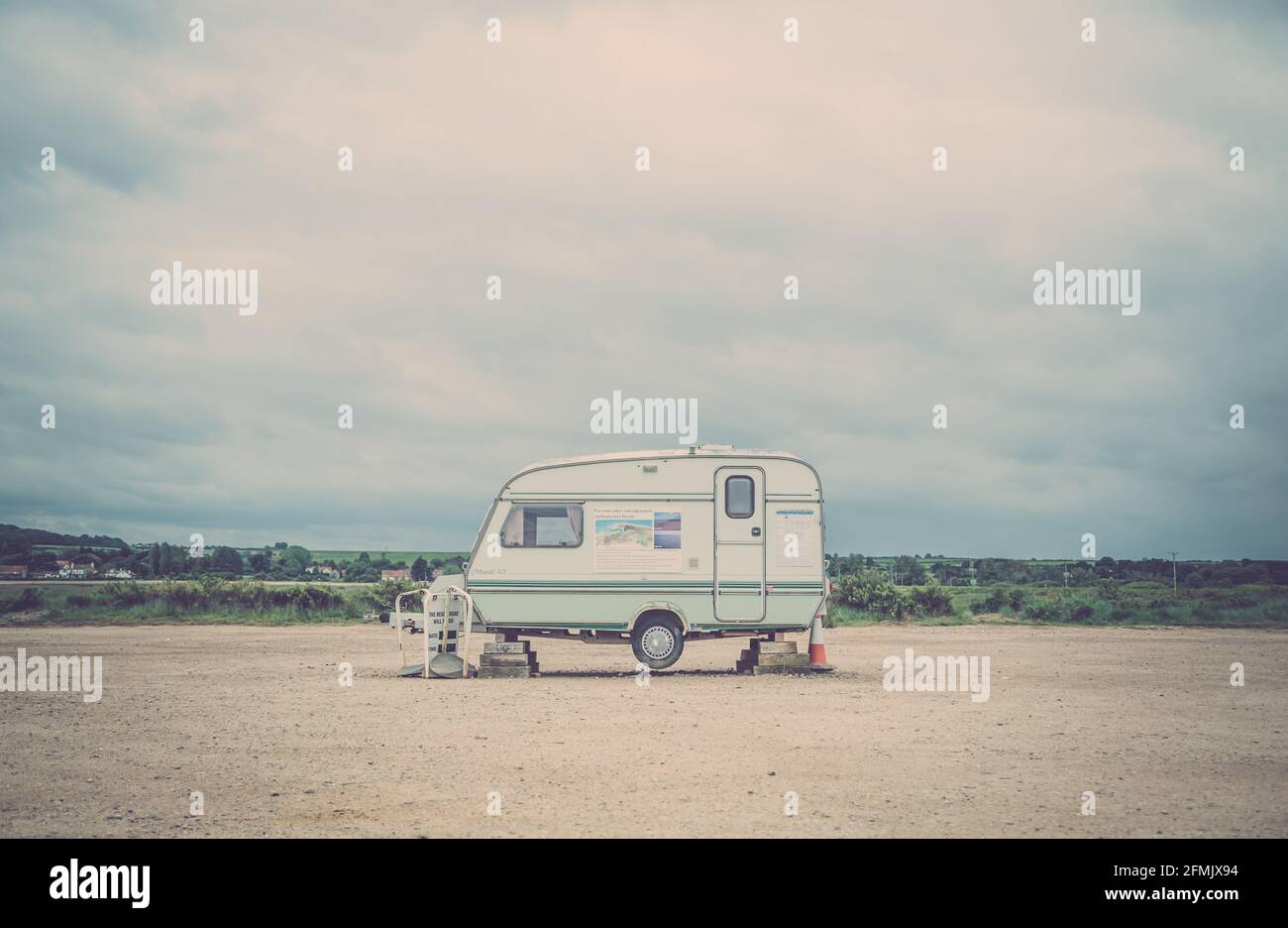 abandoned caravan in the middle of an open empty space Stock Photo - Alamy