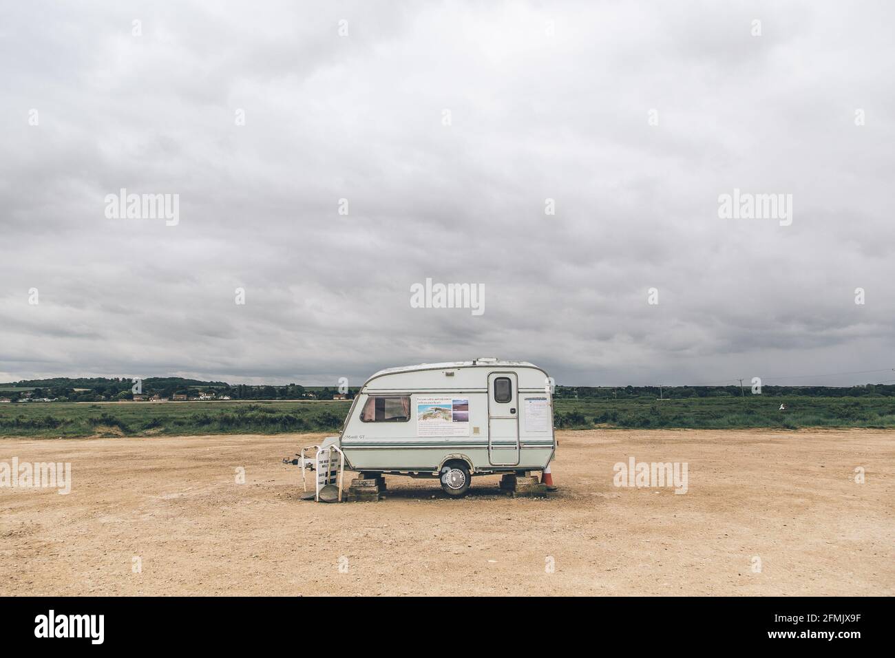 abandoned caravan in the middle of an open empty space Stock Photo - Alamy