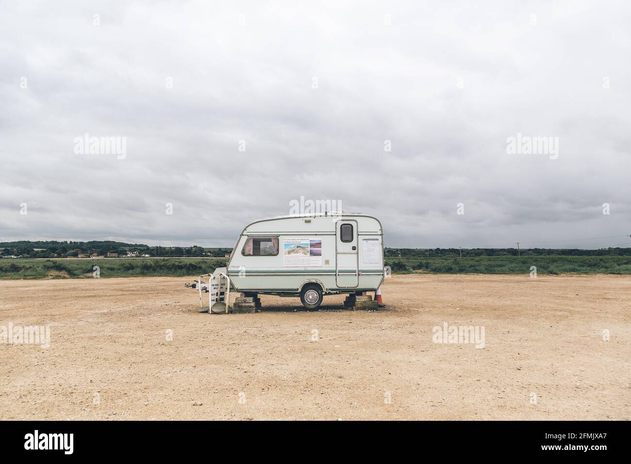 abandoned caravan in the middle of an open empty space Stock Photo - Alamy