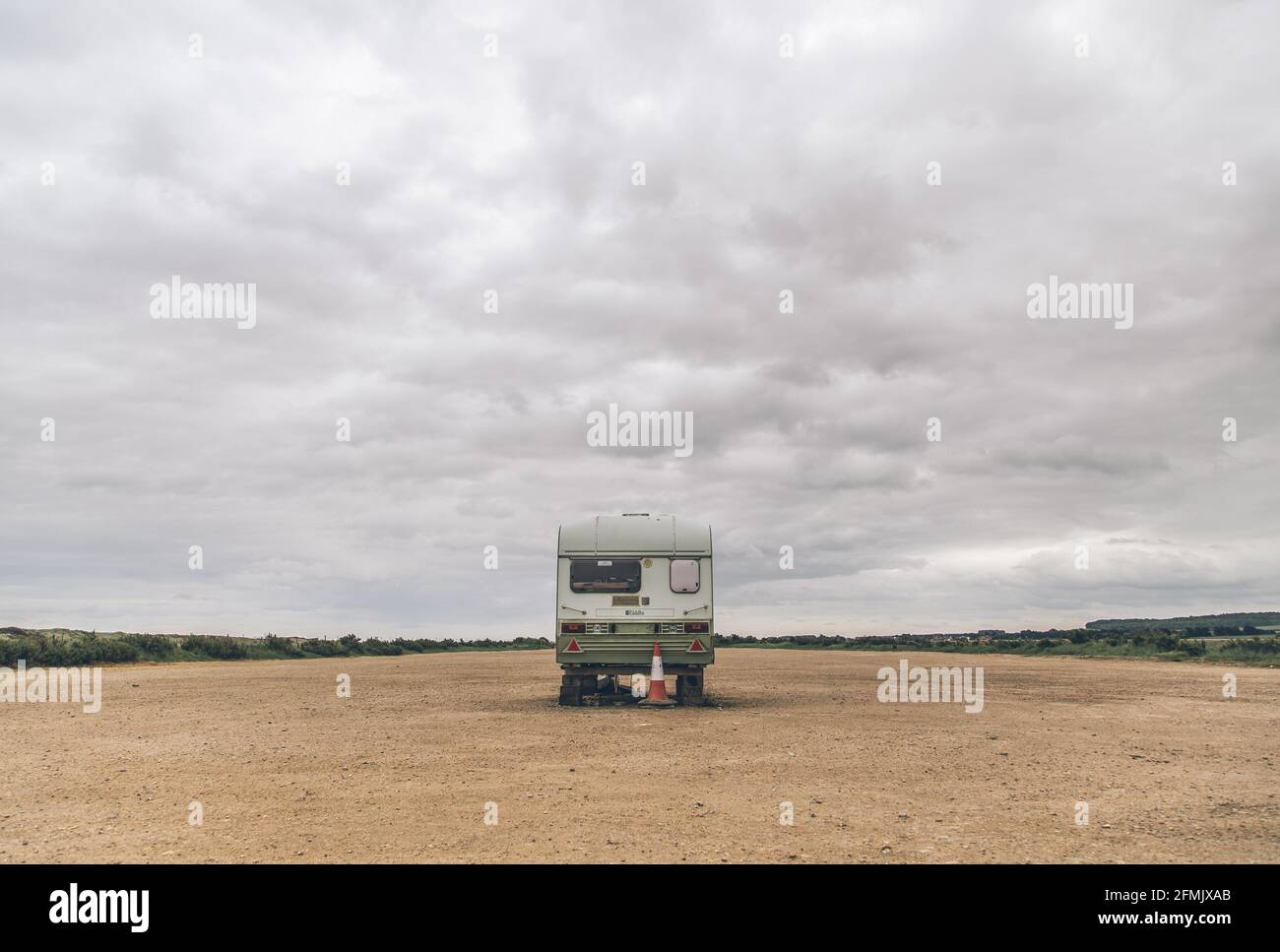 abandoned caravan in the middle of an open empty space Stock Photo - Alamy