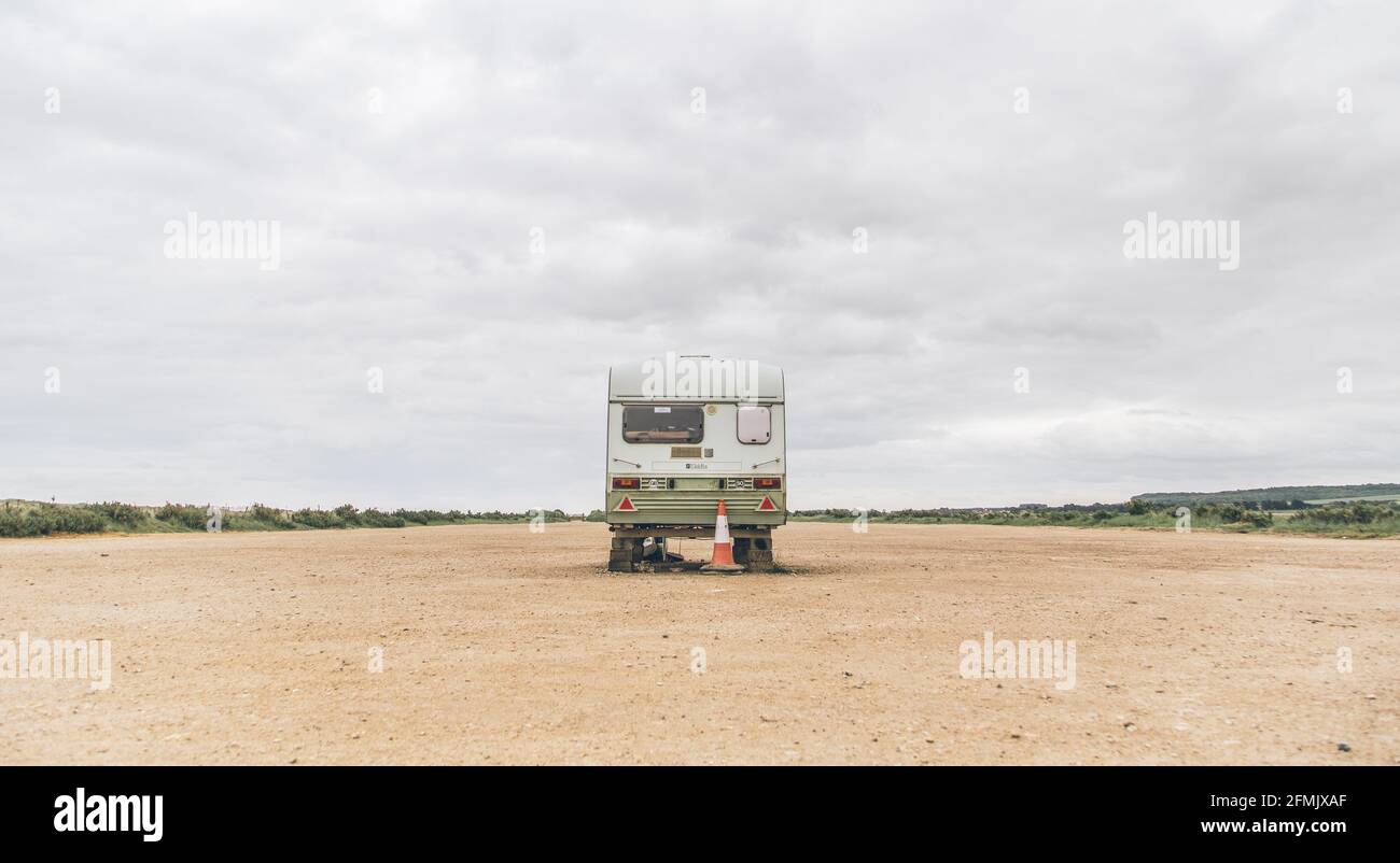 abandoned caravan in the middle of an open empty space Stock Photo - Alamy