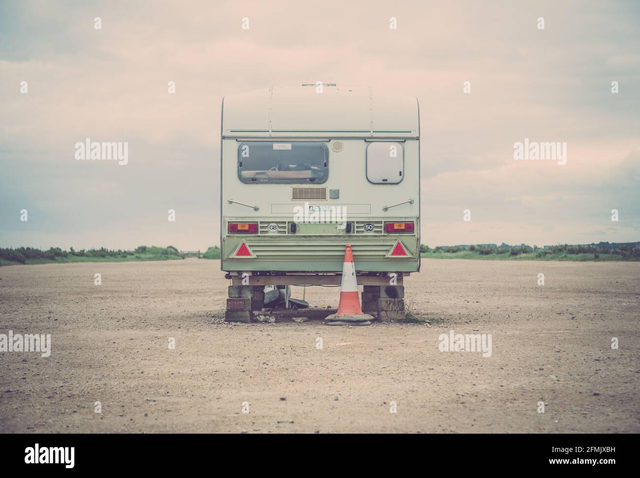 abandoned caravan in the middle of an open empty space Stock Photo - Alamy