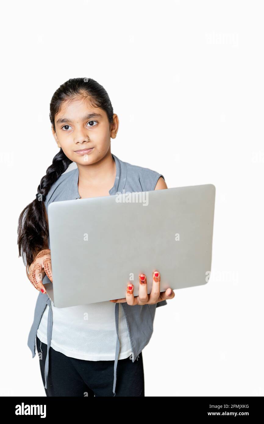 A young Indian girl is attending online school or classes. Study in ...