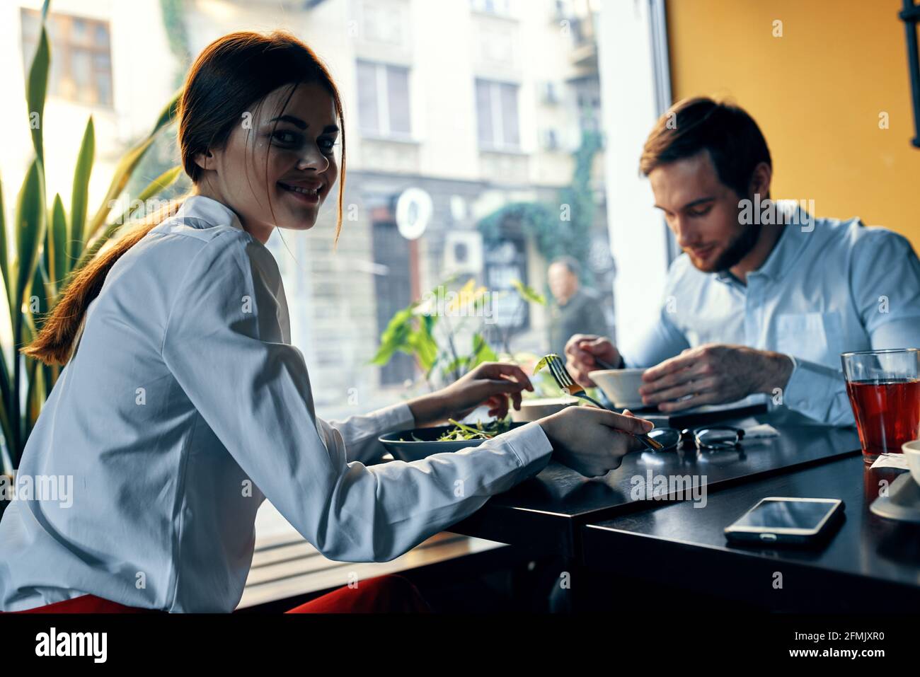 employees at a table in a cafe lunch break cooking a woman and a man ...