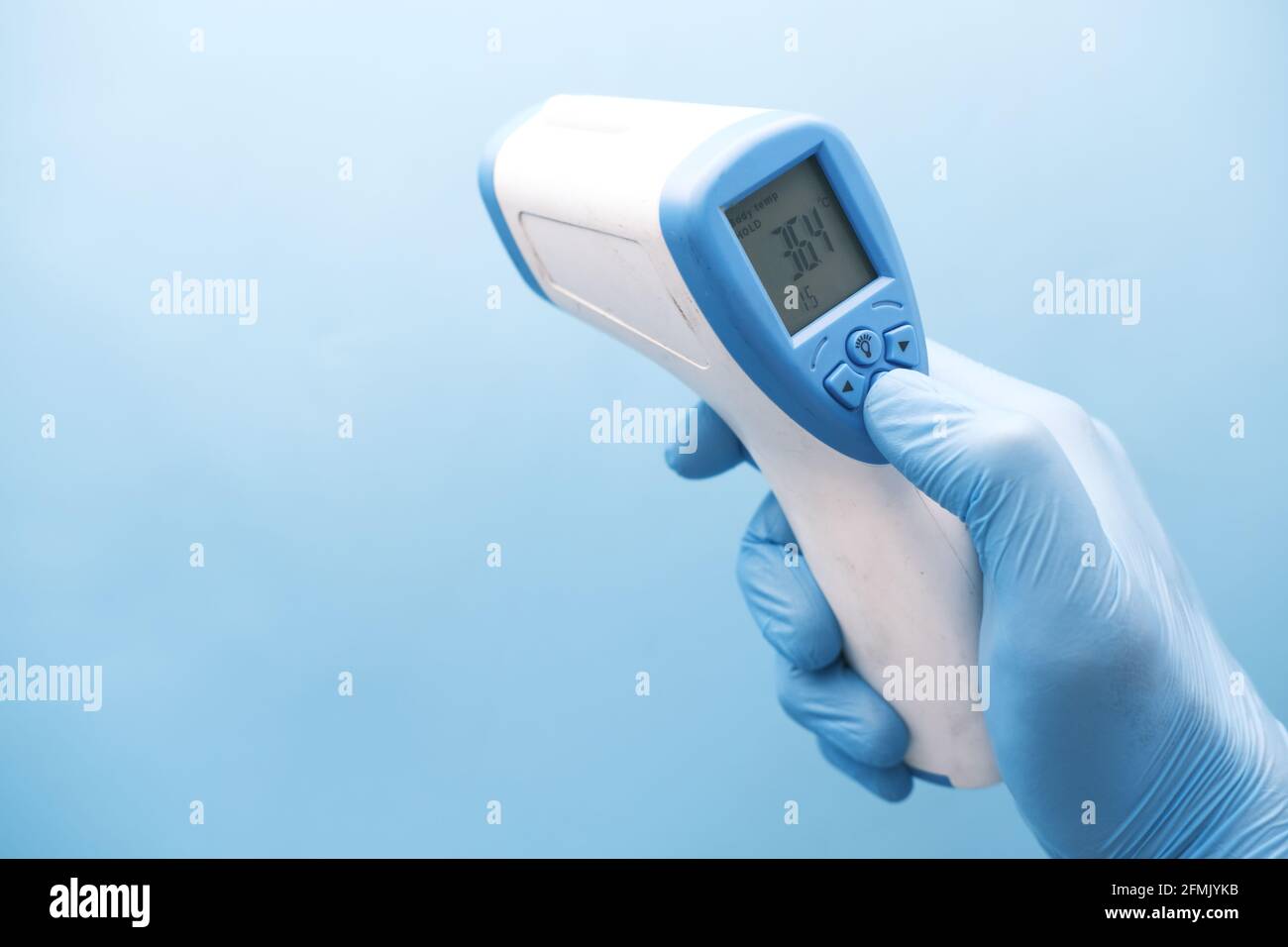 Hand holding infrared thermometer to measuring temperature Stock Photo ...