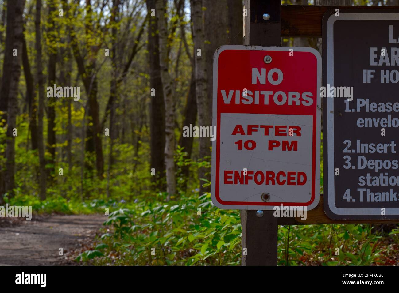 Park signs warning about not entering the park after 10 pm Stock Photo ...