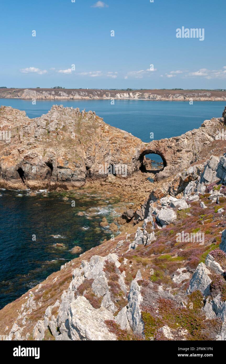 Iroise sea, natural arch and ruins of castle at Pointe de Dinan ...