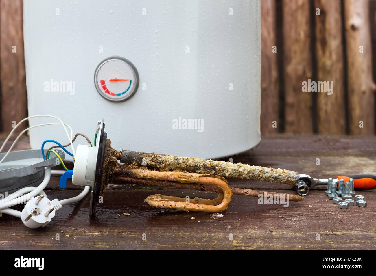 broken water heater with heating elements, on wooden background Stock ...