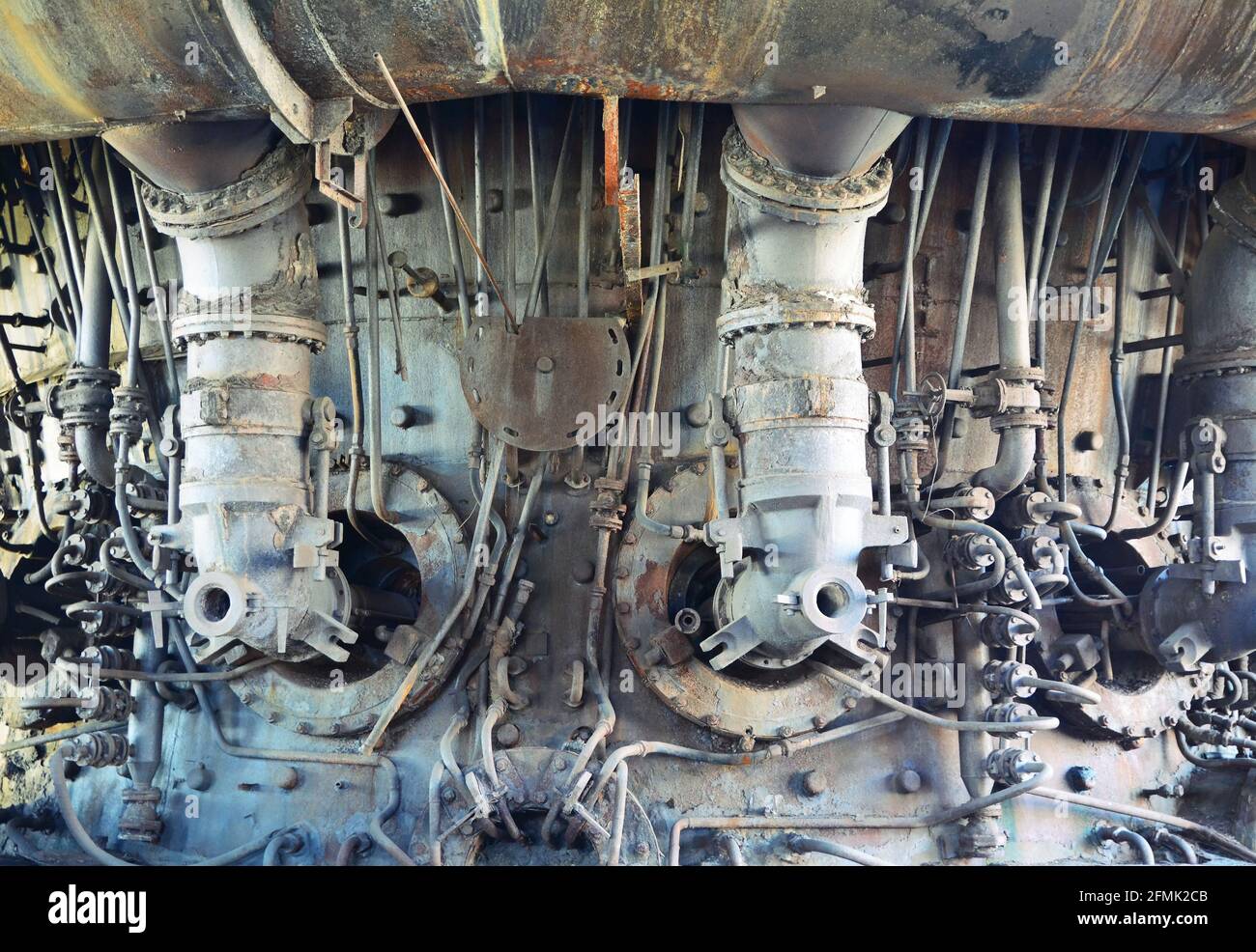 Old abandoned factory interior with many rusty piping. Rusty piping in ...