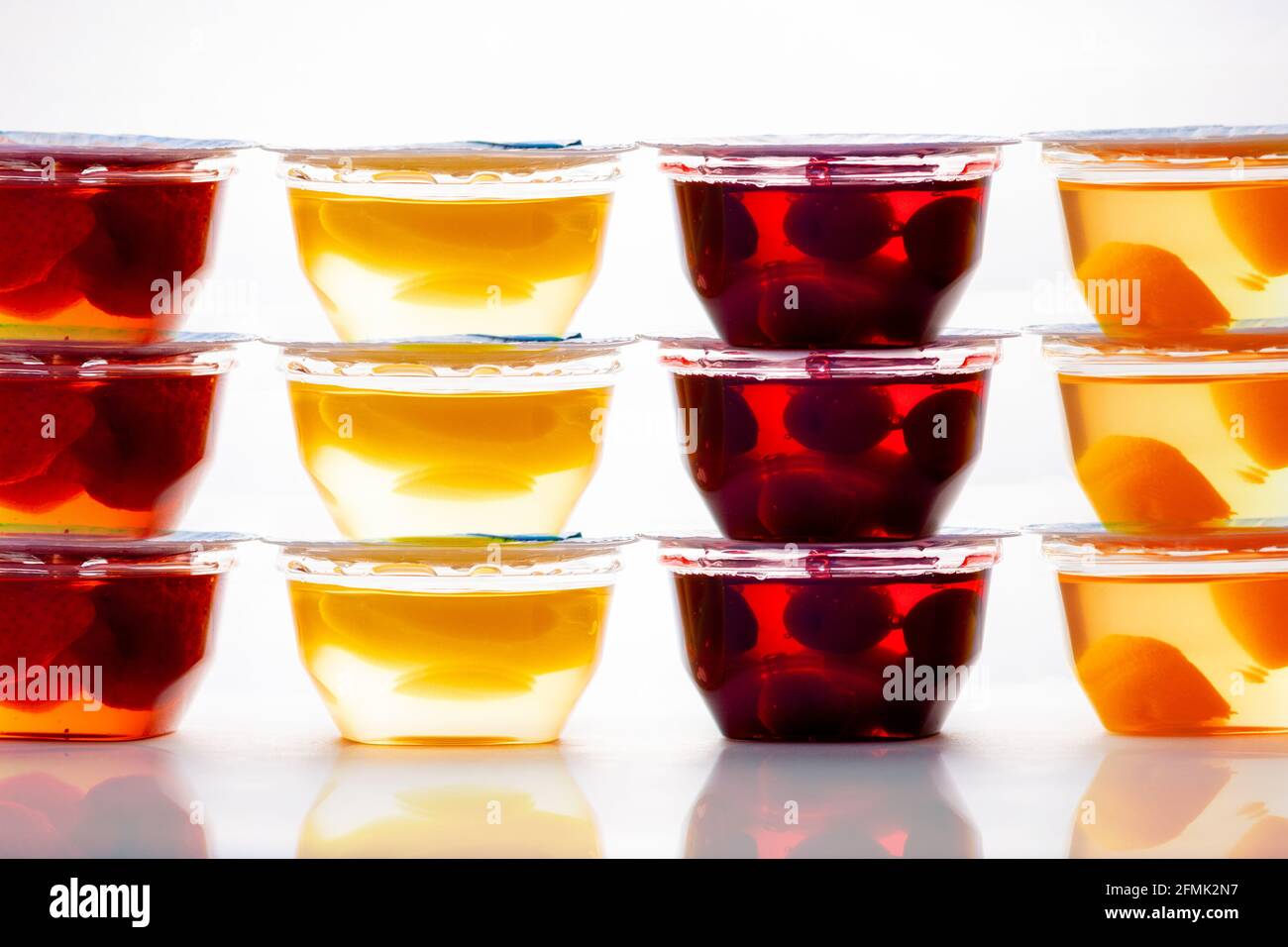 Bowls of colorful jelly, with pieces of fruits. Side view. The concept ...