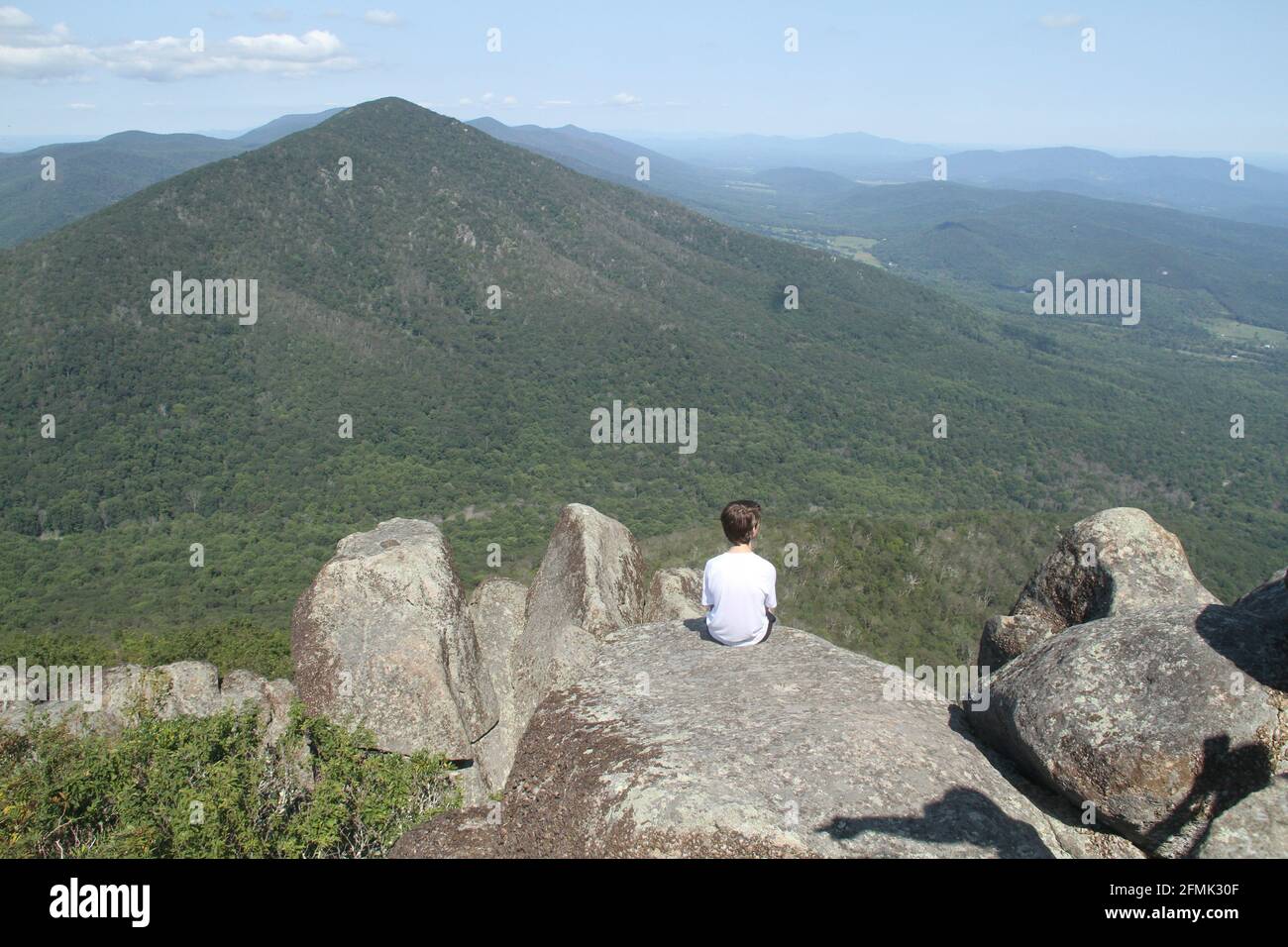 Person enjoying the panoramic views from Sharp Top on Virginia's Blue ...