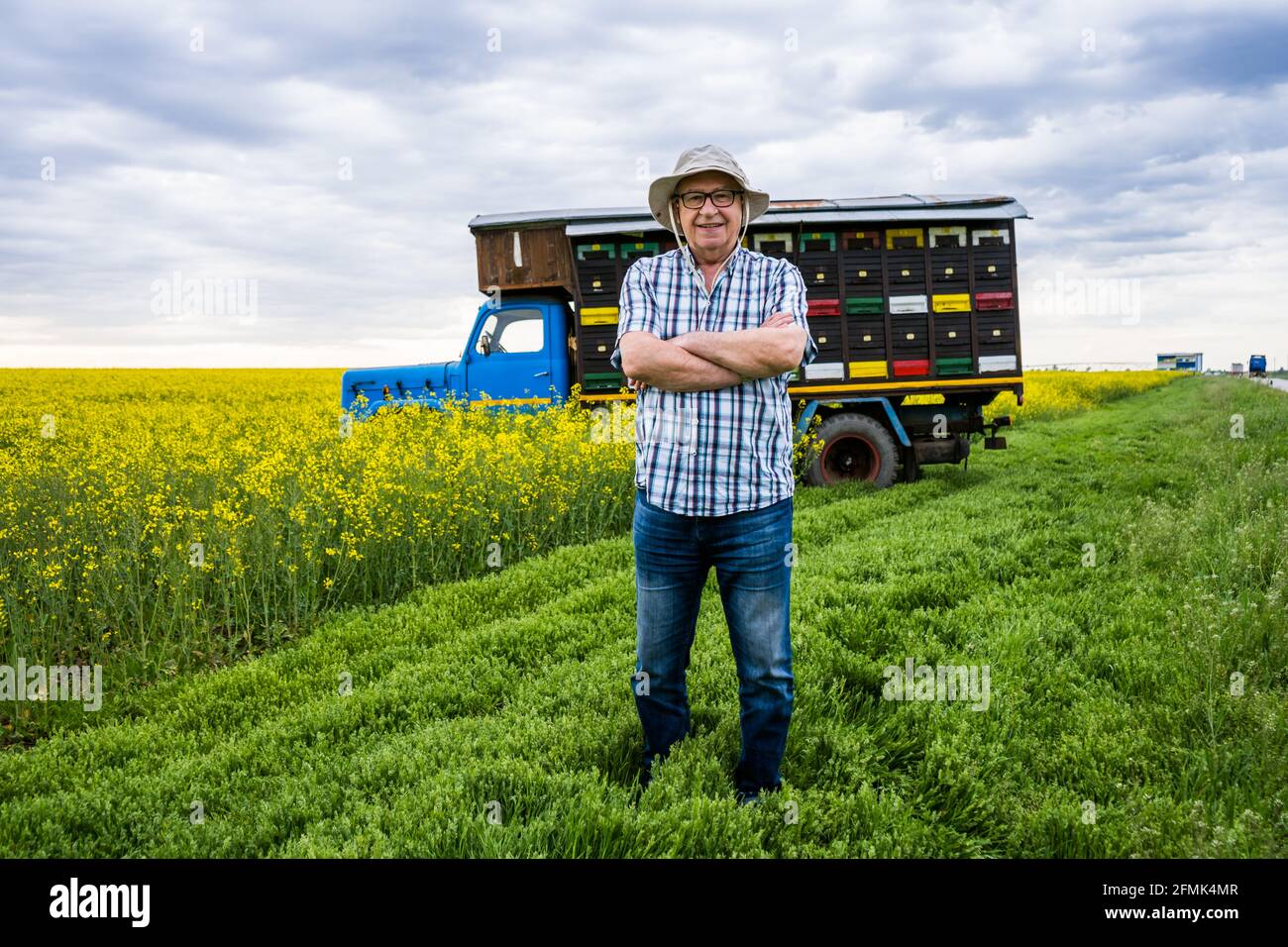 Proud beekeeper is standing in front of his truck with beehives Stock ...