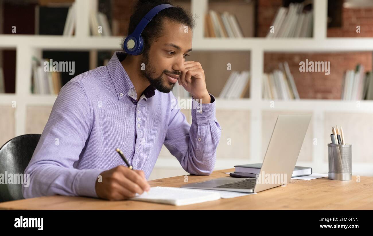 Close up African American man in headphones watching webinar, studying ...
