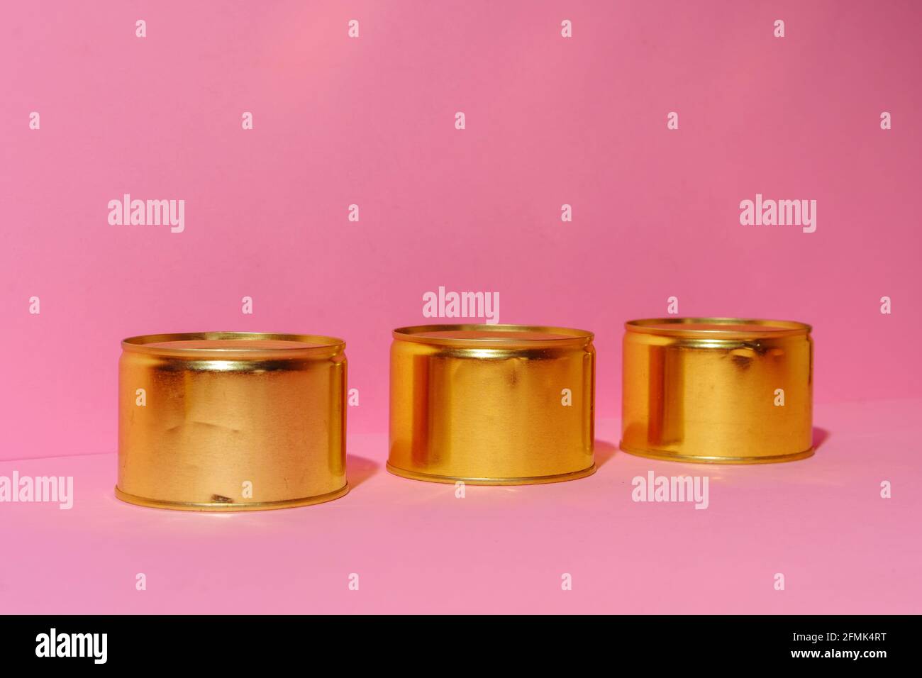 Canned food tin on pink studio background Stock Photo - Alamy