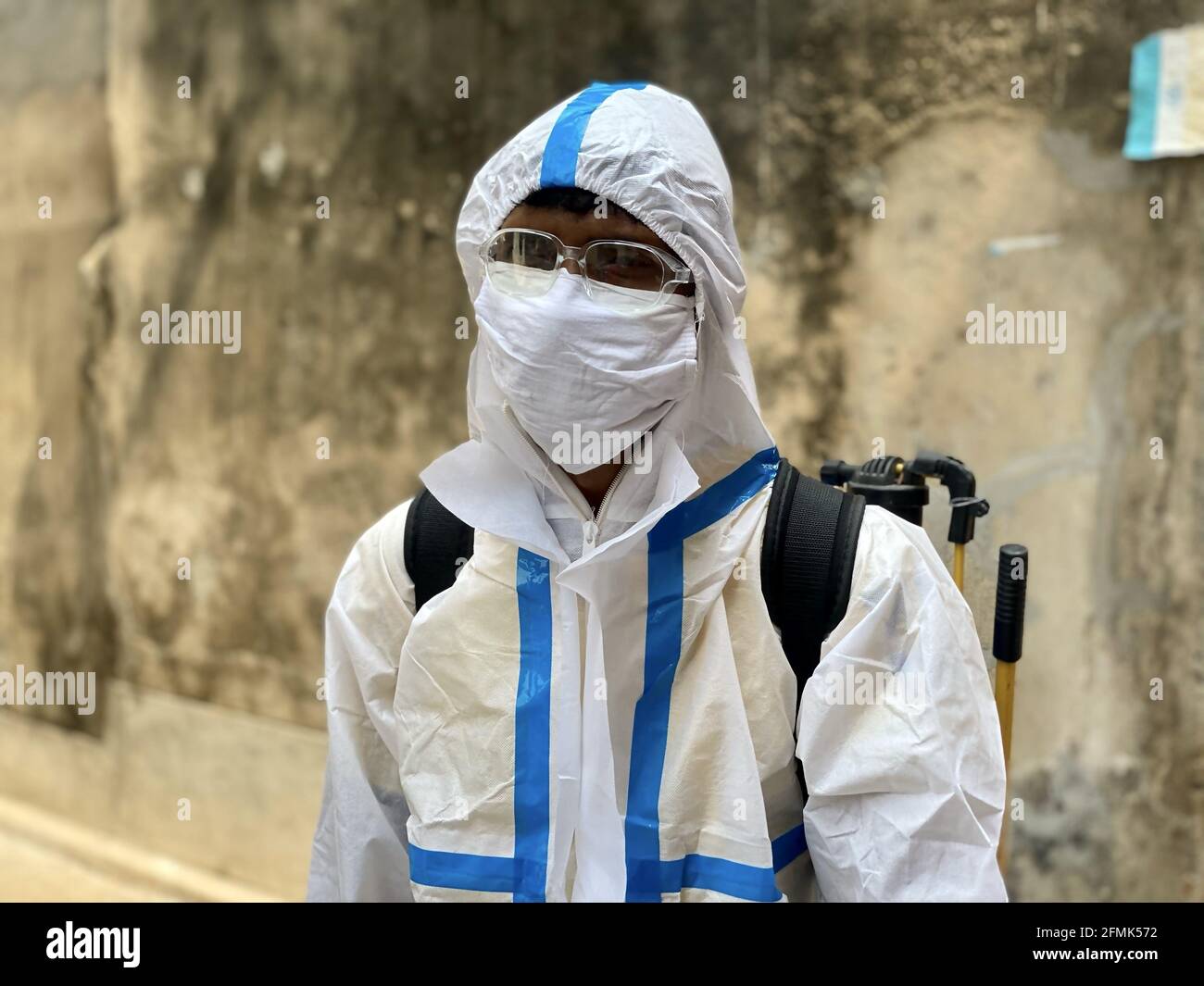Shallow focus of an Asian healthcare worker in a PPE suit in India ...