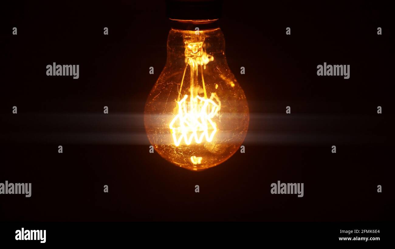 Vintage Edison light bulb reproduction on black background Stock Photo ...