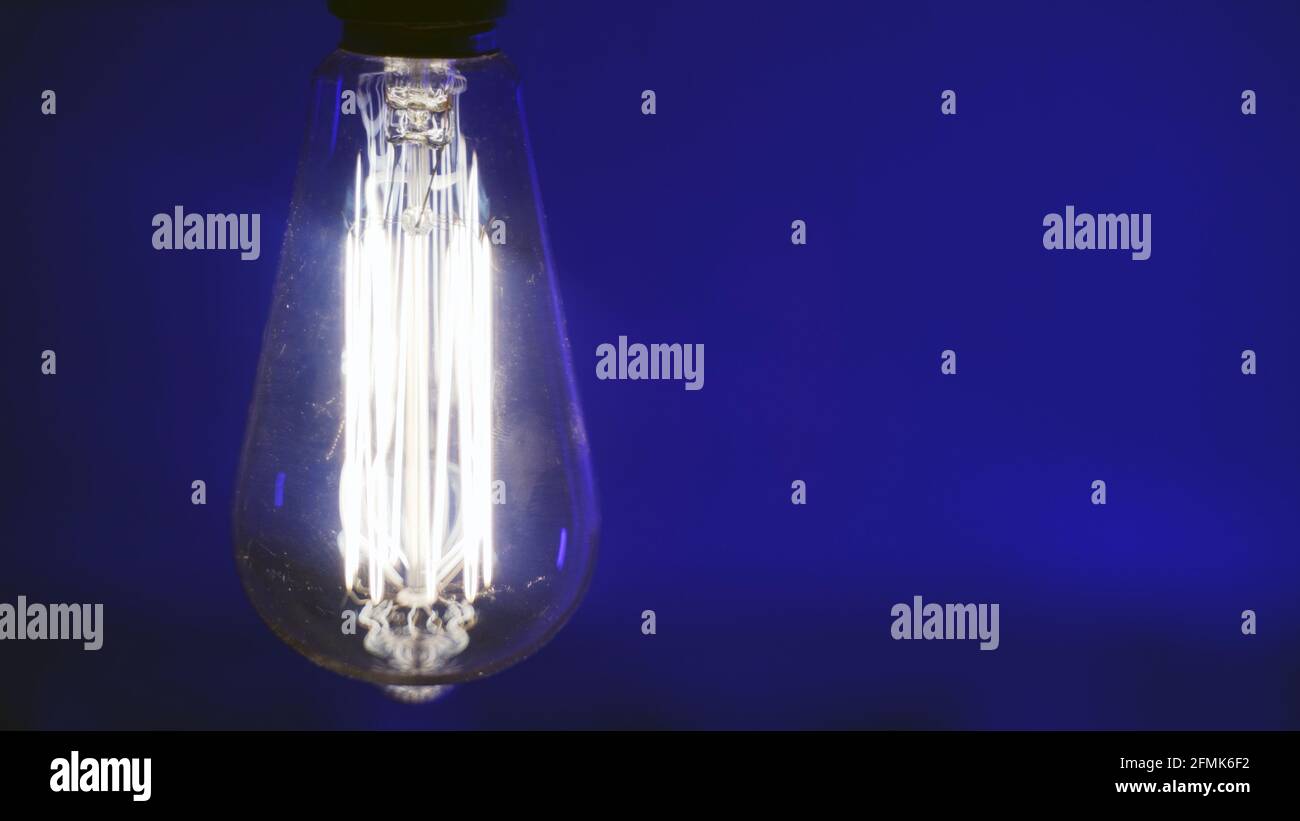 Vintage Edison light bulb reproduction on blue background Stock Photo ...