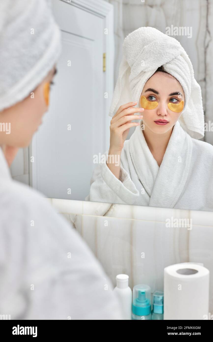 Beautiful Woman With Eye Patches In White Bathrobes In Bathroom Stock