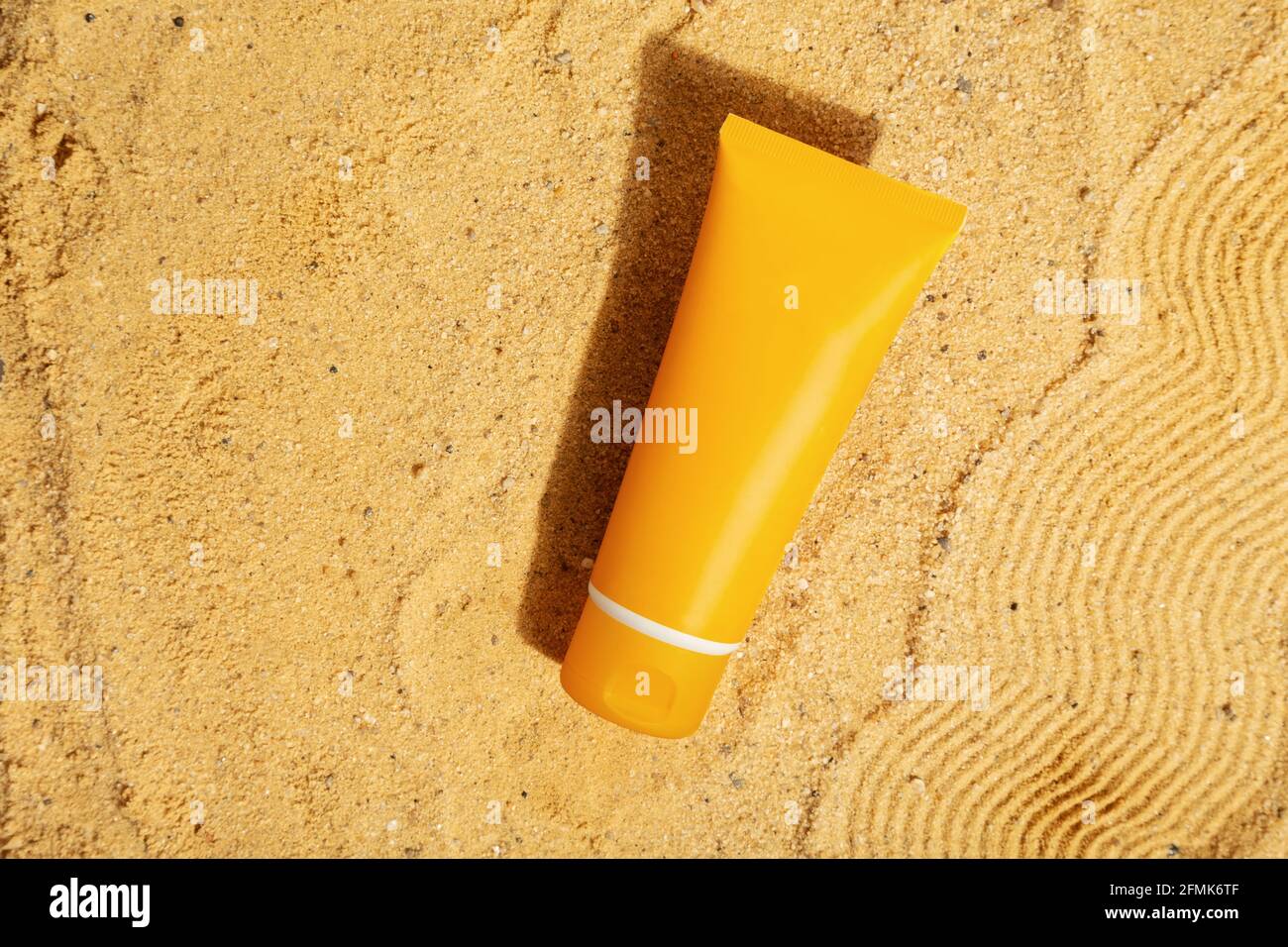 Orange tube of sunscreen on beach sand. Sun Protection. Top view Stock ...