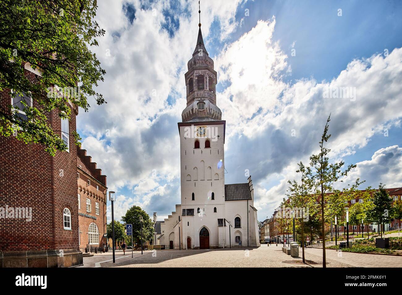 a tall white church tower with gold clock Stock Photo - Alamy