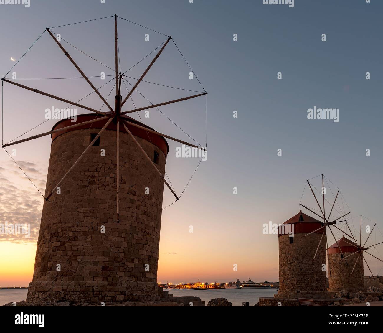 The windmills near Rhodes old town mandraki harbor at sunrise Stock ...