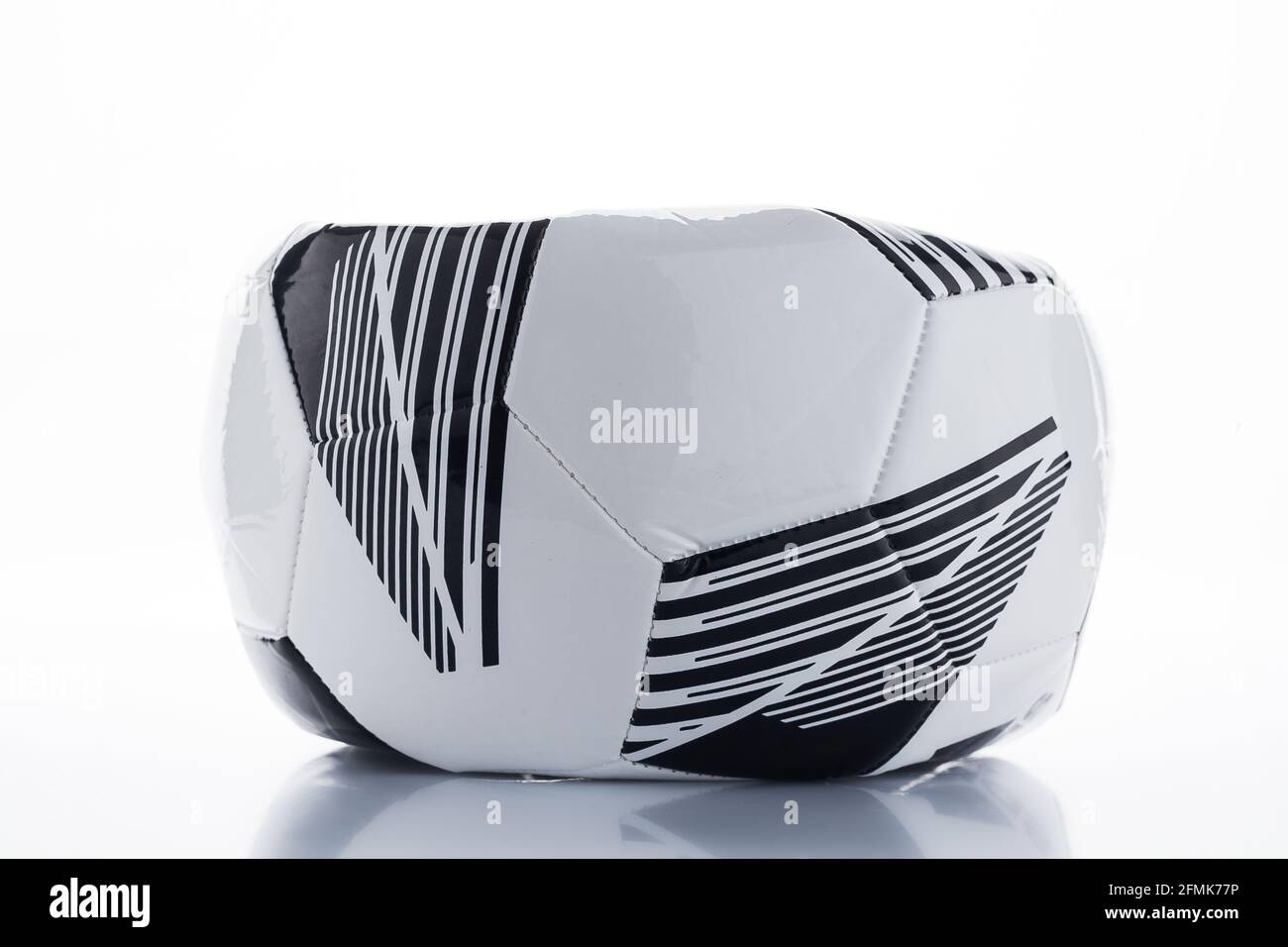 Deflated soccer, football ball on a white background Stock Photo - Alamy