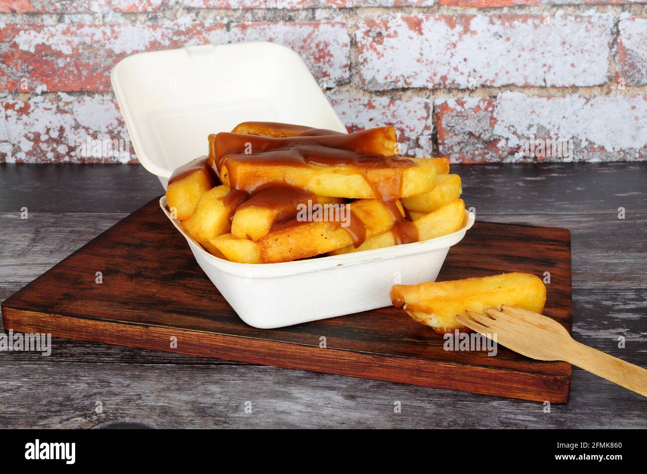 Chips and gravy meal in a take away box with lid Stock Photo - Alamy