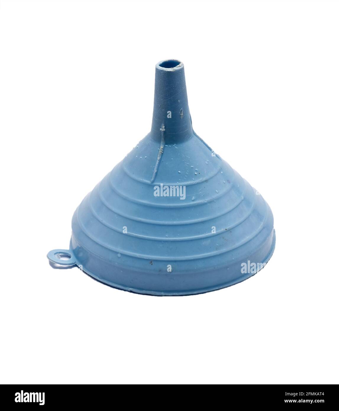 The used old blue colored plastic funnel stands on a white background ...