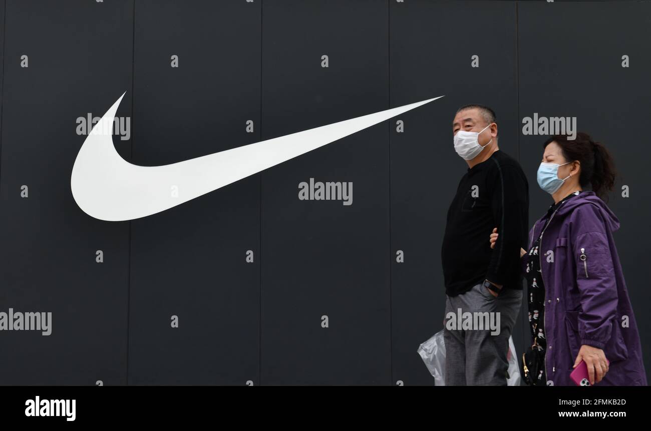 BEIJING, CHINA - MAY 10, 2021 - Pedestrians pass in front of the Nike ...