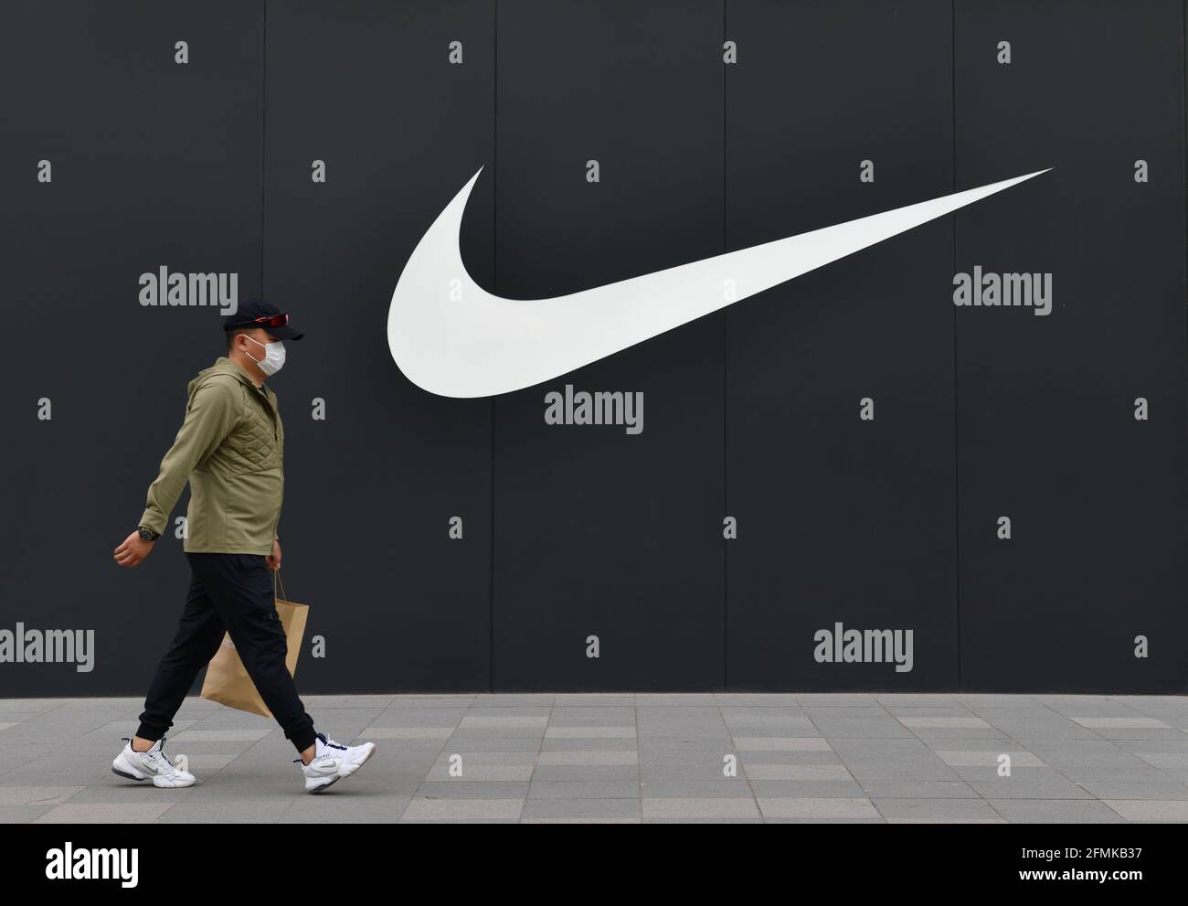 BEIJING, CHINA - MAY 10, 2021 - A pedestrian passes in front of the ...