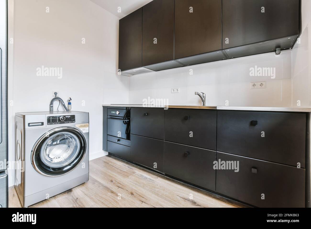 Modern kitchen with washing machine Stock Photo - Alamy