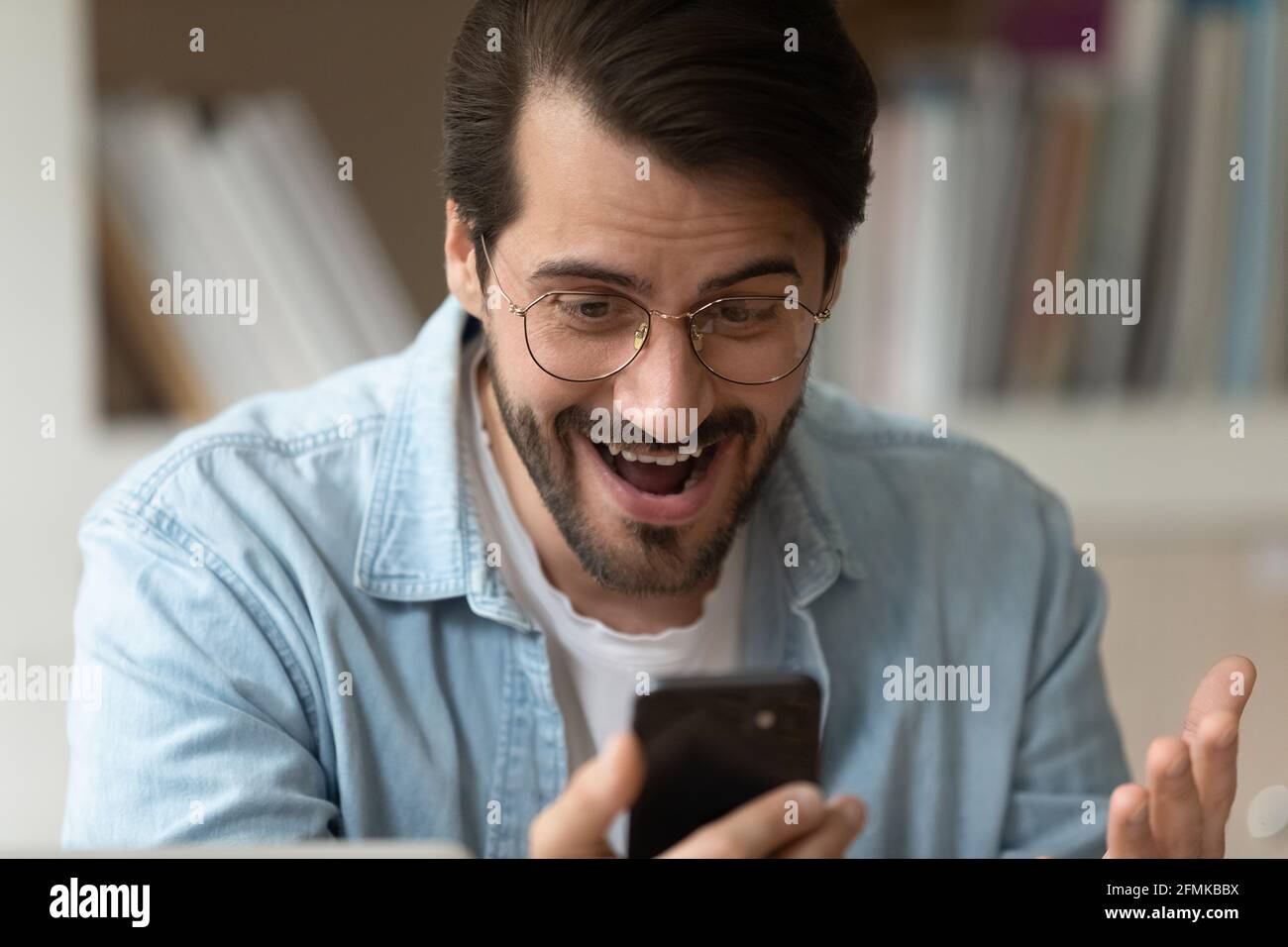 Close up surprised man in glasses looking at phone screen Stock Photo ...