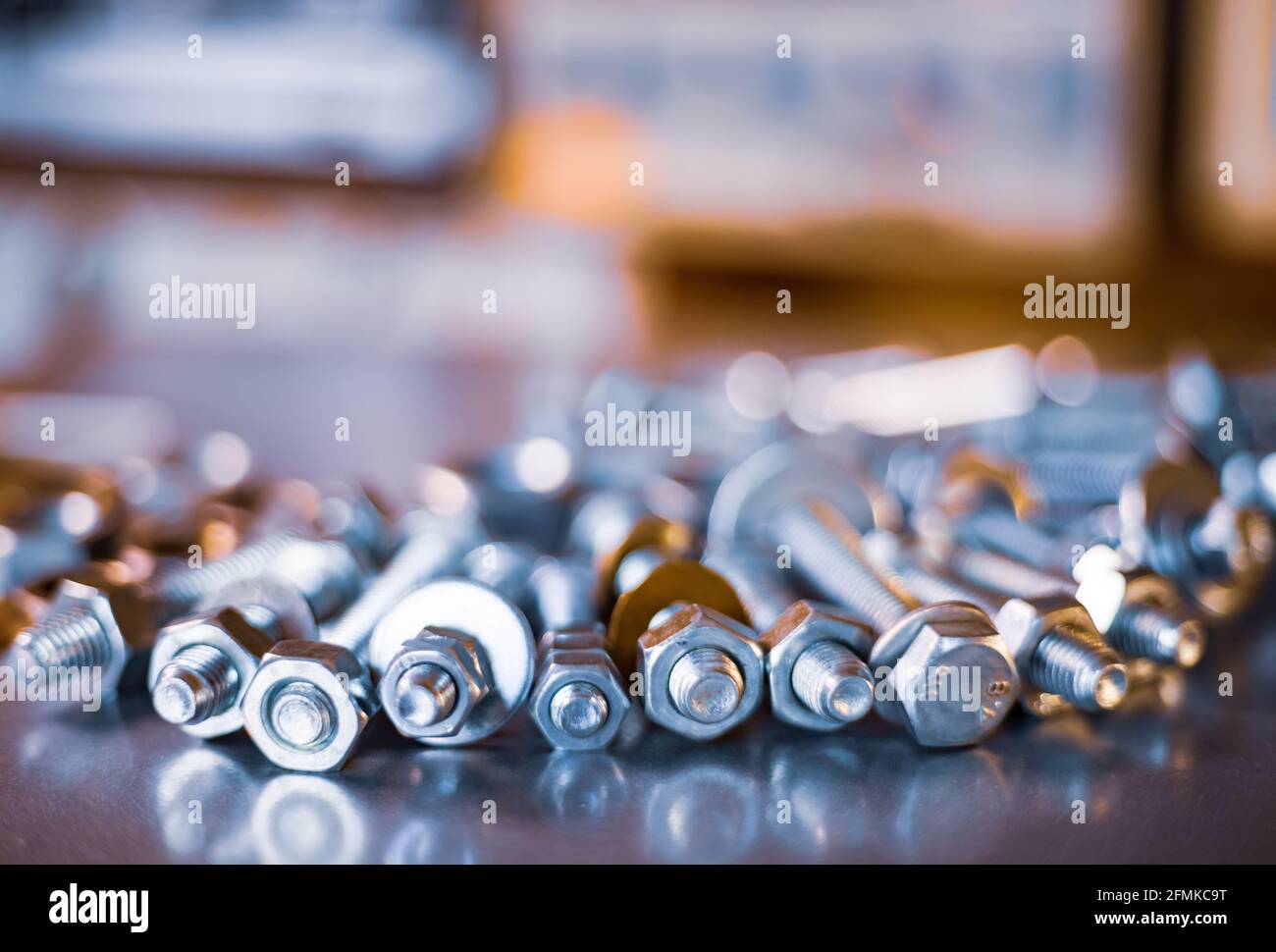 Metal chrome bolts and nuts in a chaotic order industrial background ...