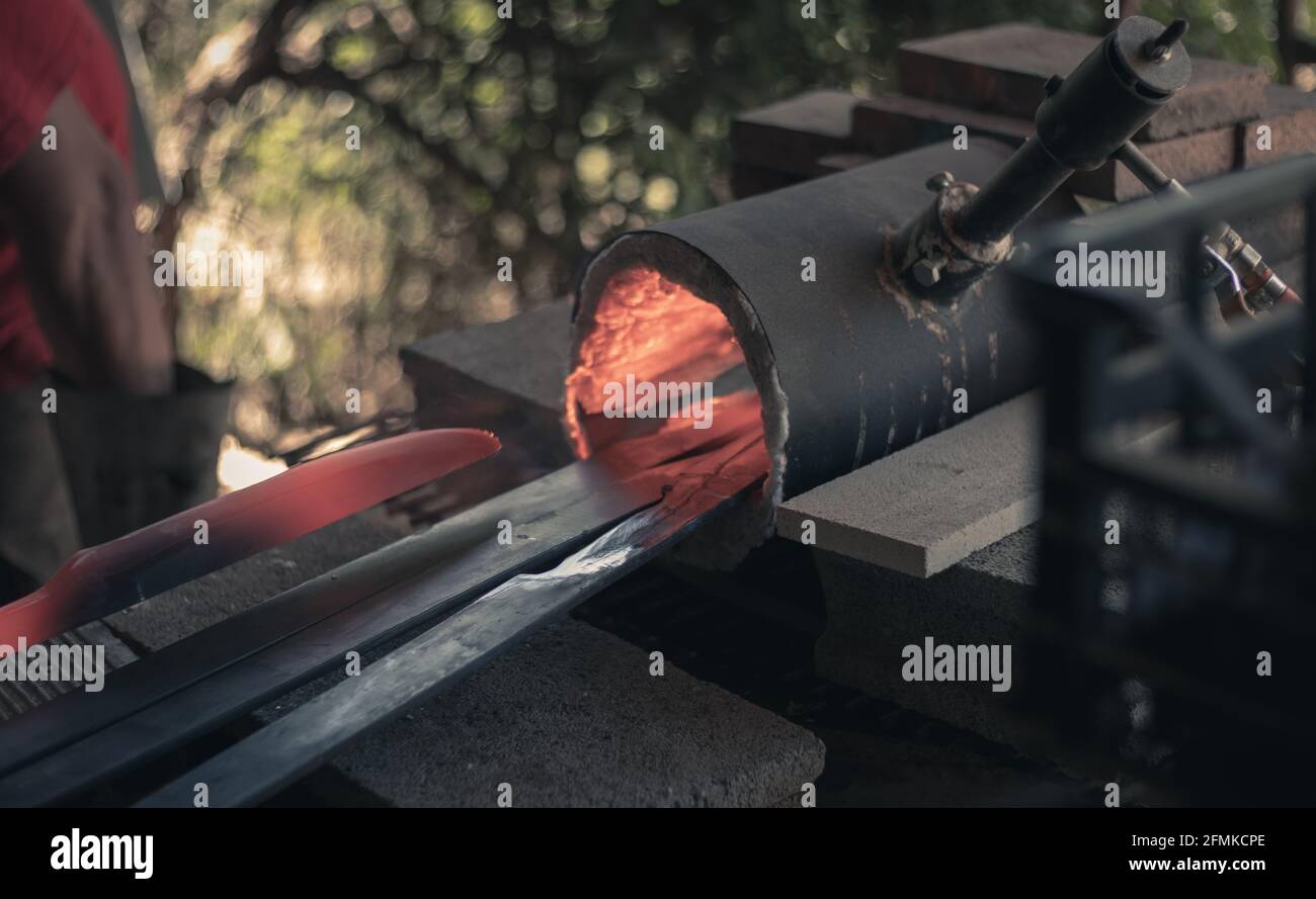 Heating steel in a gas forge Stock Photo - Alamy