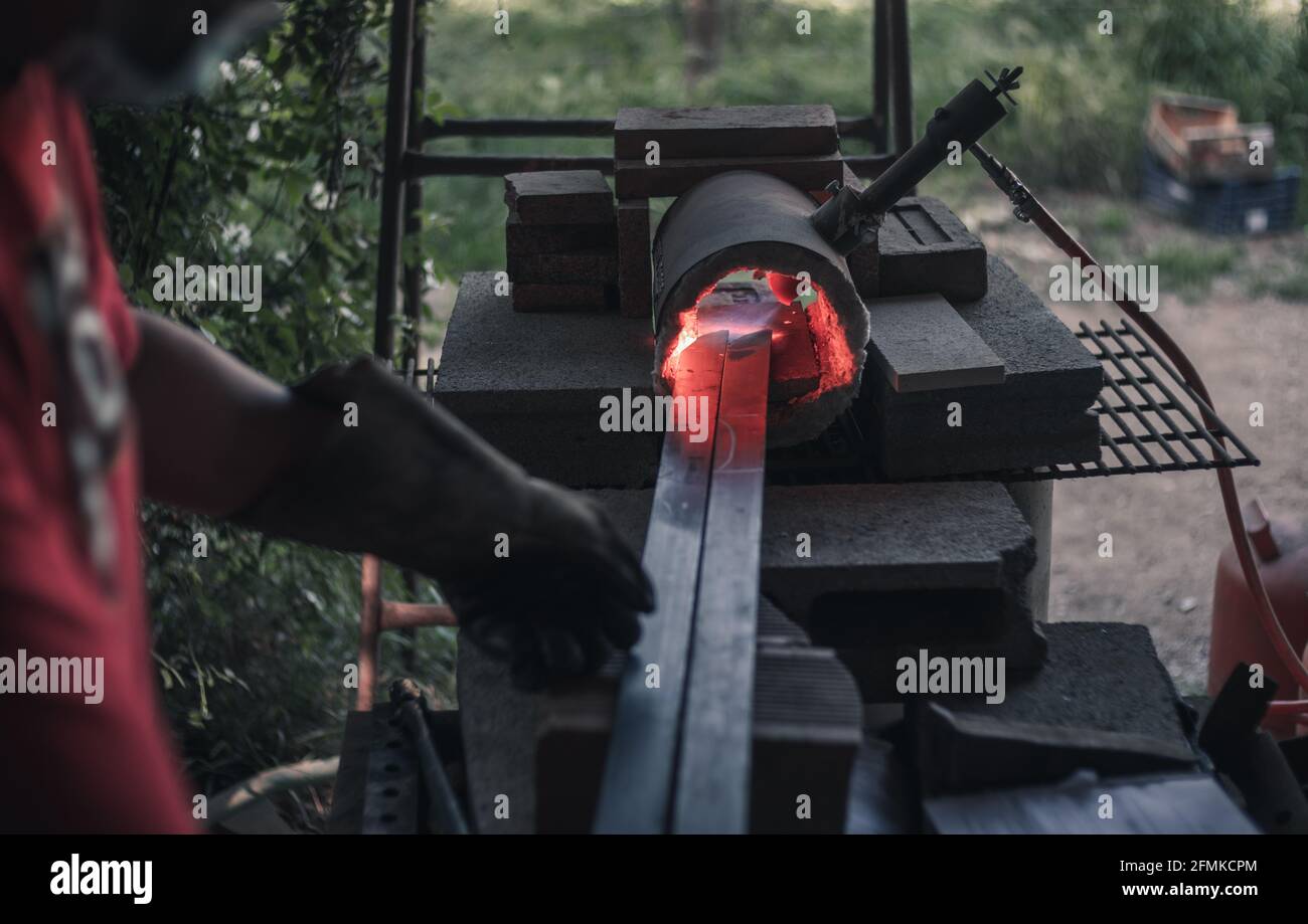 Heating steel in a gas forge Stock Photo - Alamy