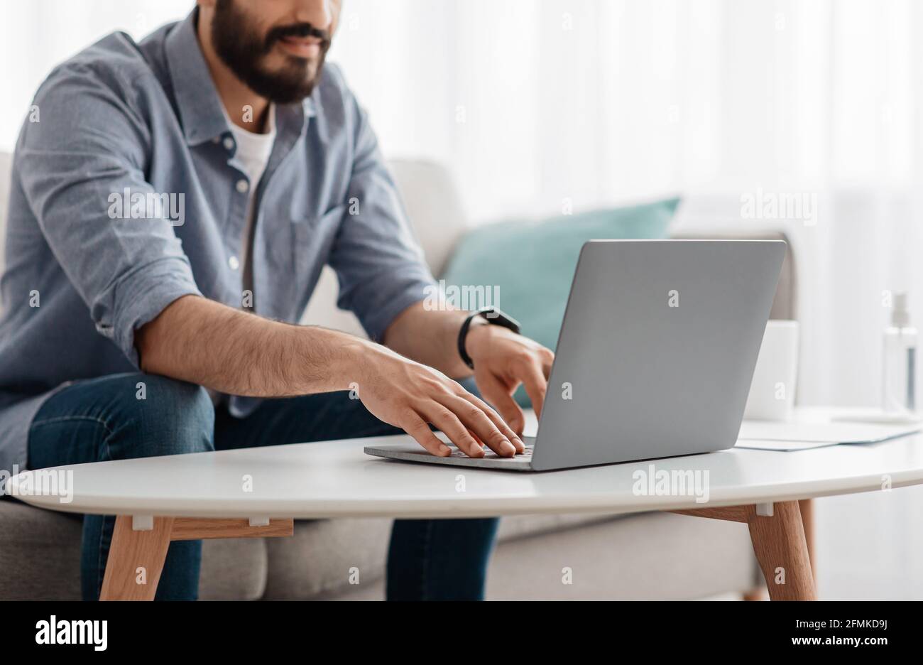 Unrecognizable bearded man working on pc, typing text or programming ...