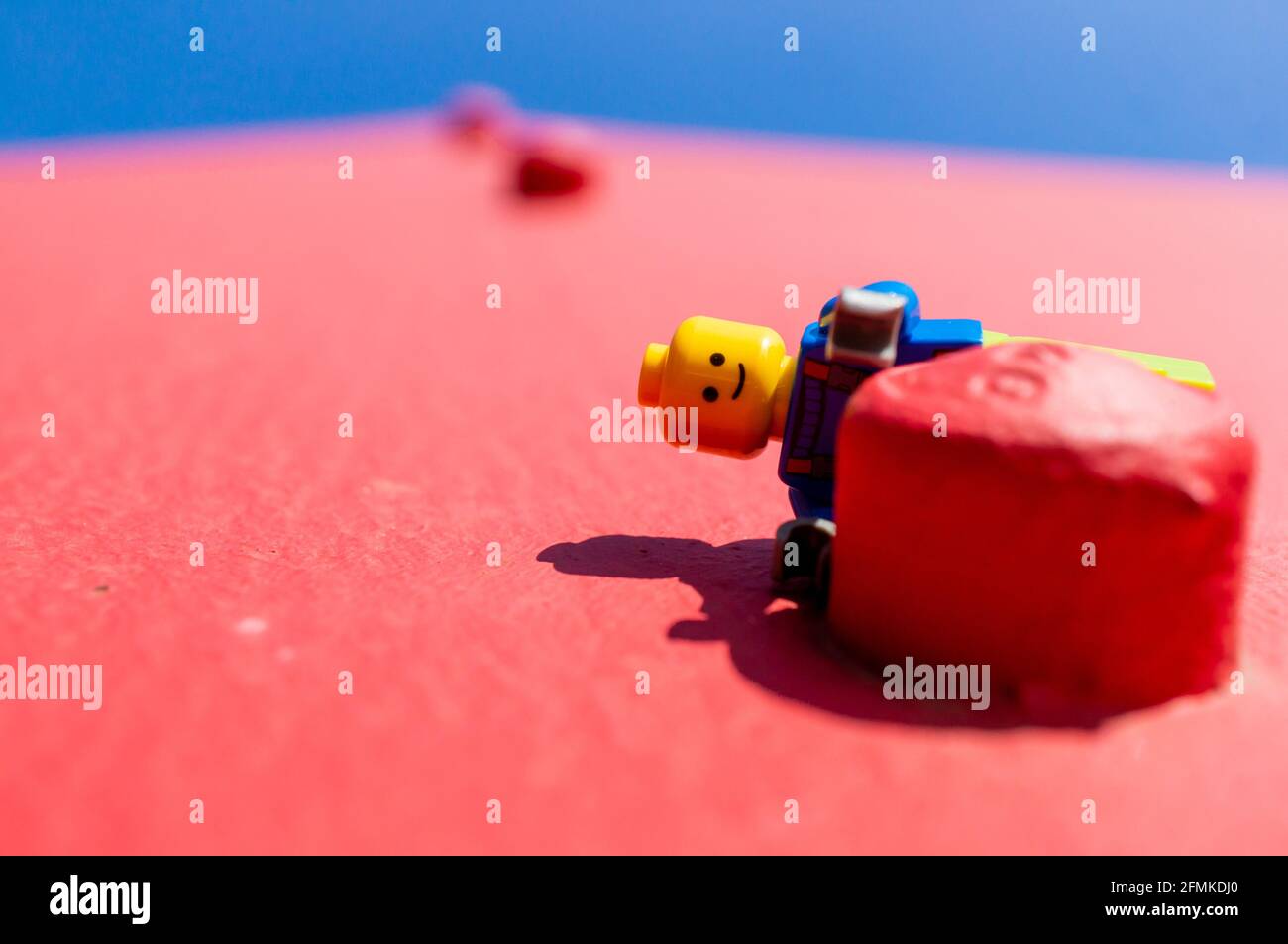 POZNAN, POLAND - Mar 30, 2021: Lego man toy figurine laying on a red ...