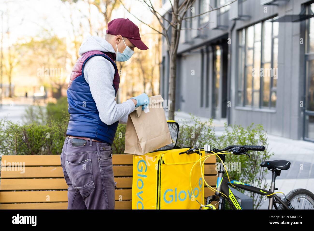 KIEV, UKRAINE - 28 April, 2021: Glovo delivery boy with famous yellow ...