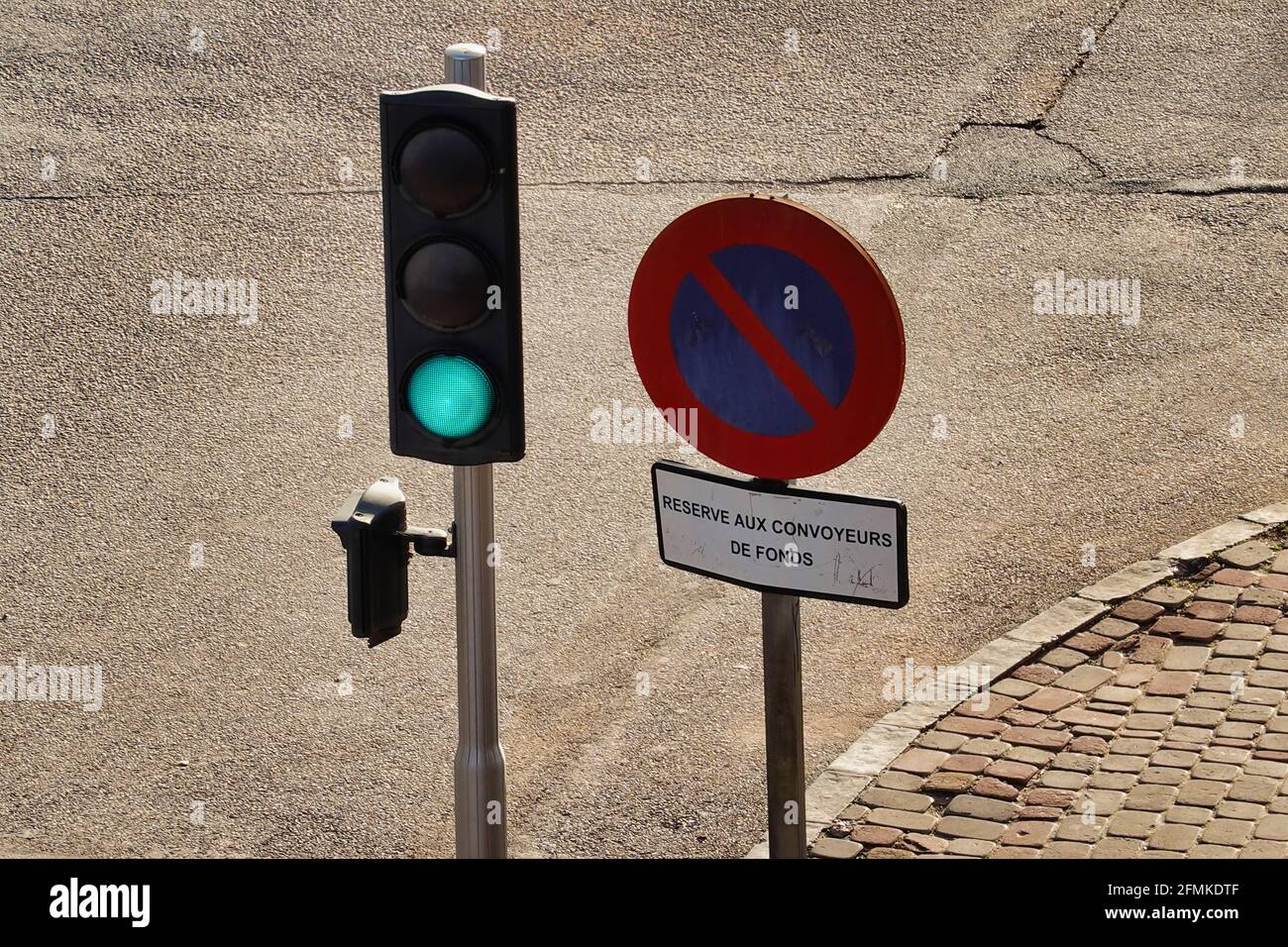 Shot of a green traffic light and road sign Stock Photo - Alamy