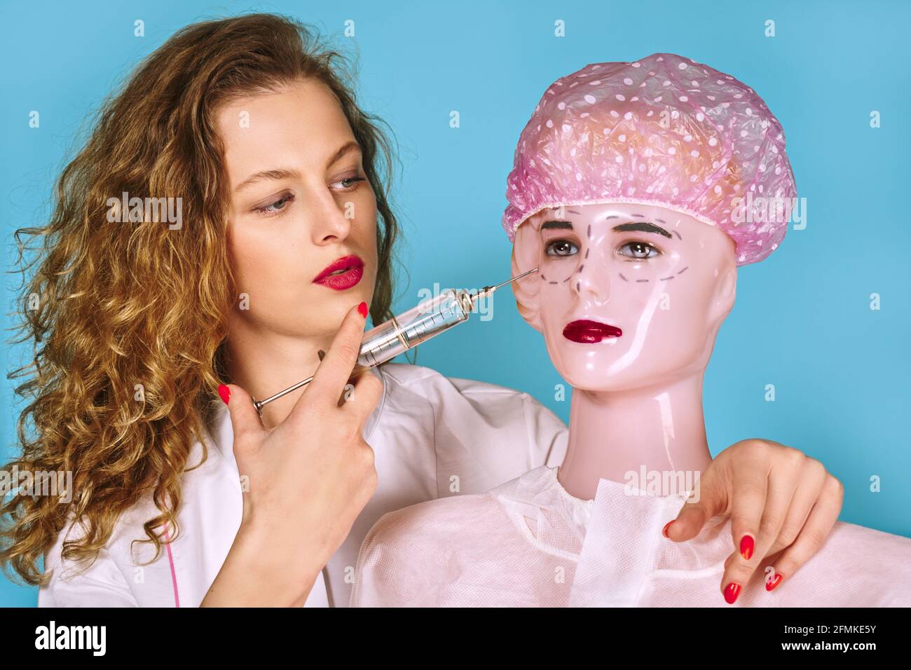 woman doctor plastic surgeon injects an injection with syringe. patient ...