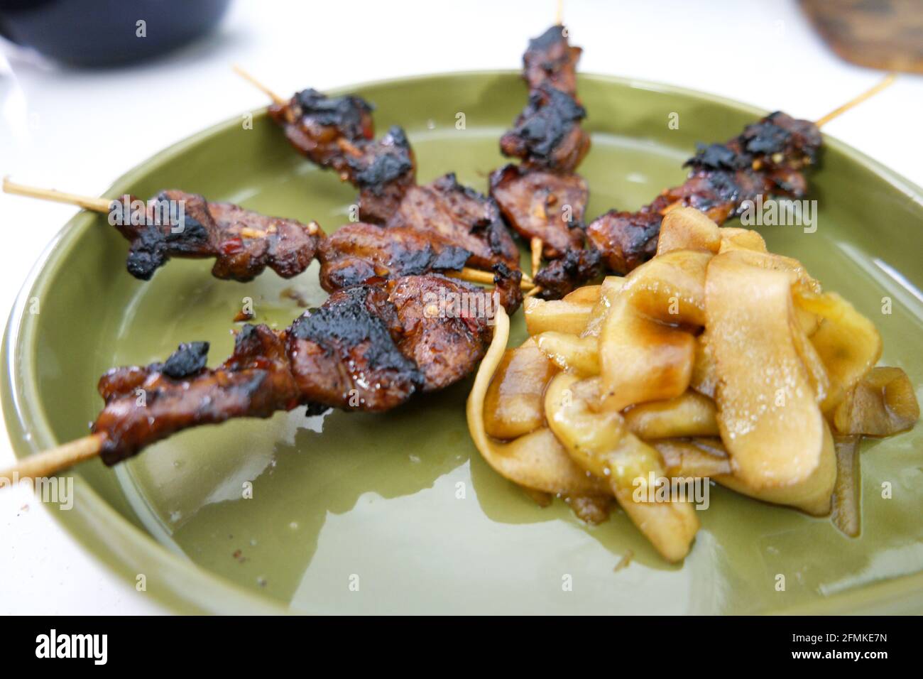 Green plate of Chicken Satay Stock Photo - Alamy