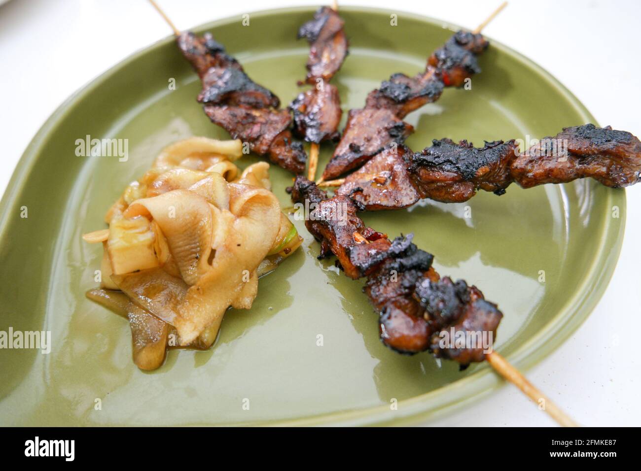 Green plate of Chicken Satay Stock Photo - Alamy