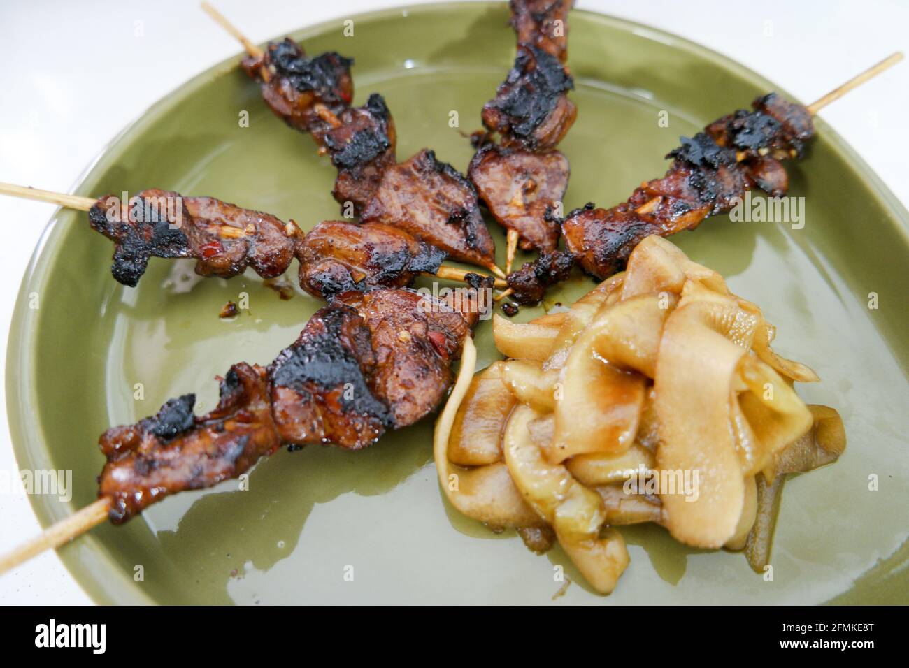 Green plate of Chicken Satay Stock Photo - Alamy