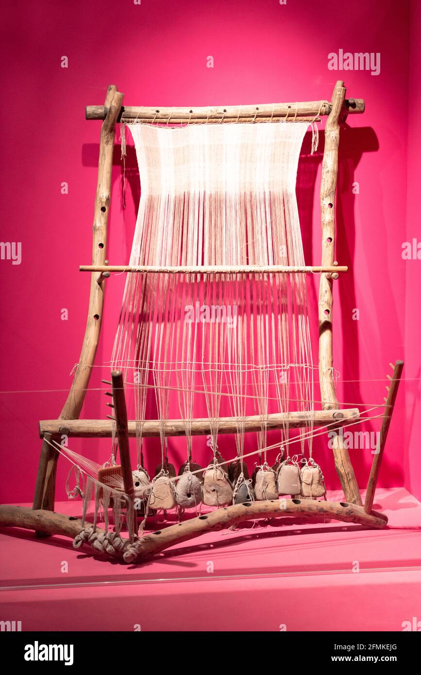 Vintage hand spinning wheel. An ancient loom made of pieces of wood and ...