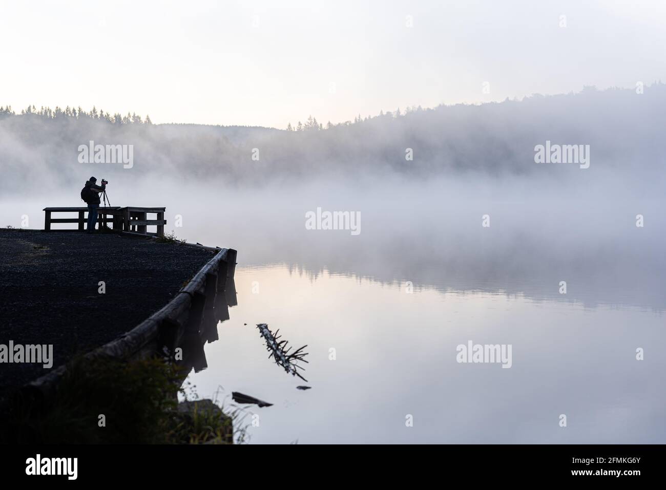 Spruce Knob Lake in West Virginia at sunrise with photographer man with ...