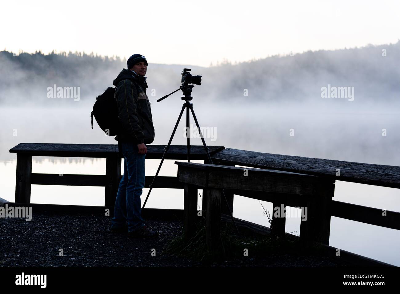 Spruce Knob Lake in West Virginia at sunrise with photographer man with ...